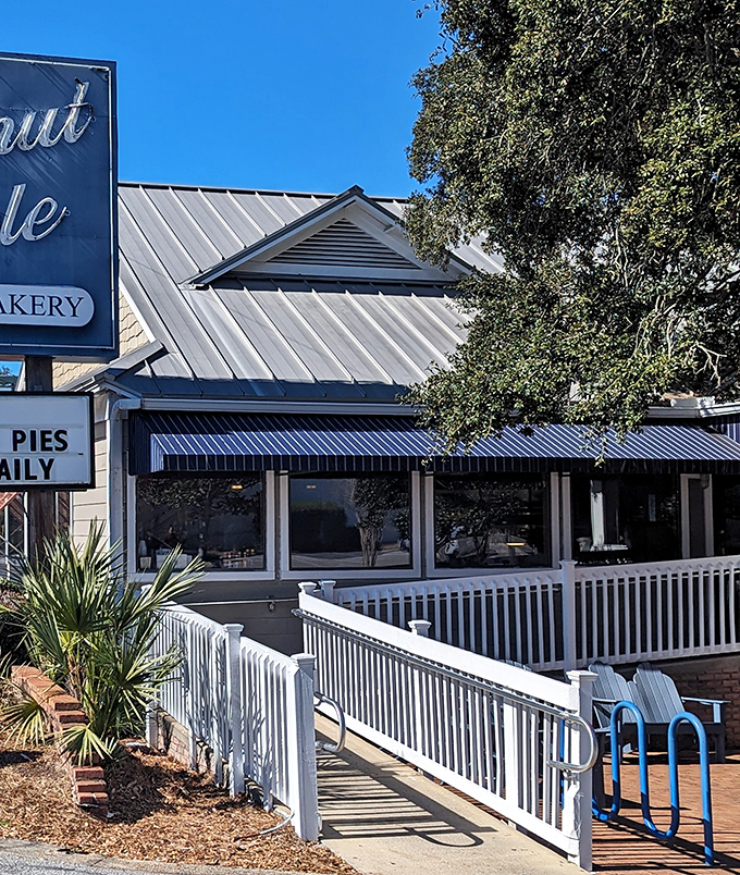 The iconic blue-trimmed exterior of Donut Hole beckons like a siren song to hungry travelers. That white picket fence isn't just charming—it's crowd control for the breakfast rush!