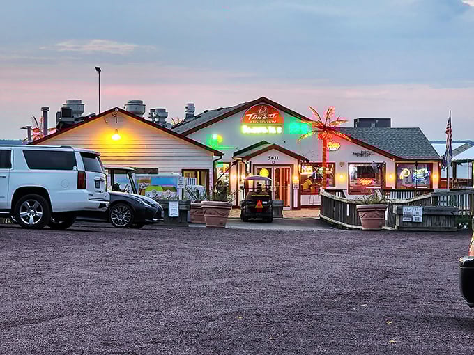 As dusk settles, Tim's II transforms into a neon-lit beacon for hungry travelers. The palm tree's glow promises tropical flavors in Virginia waters.