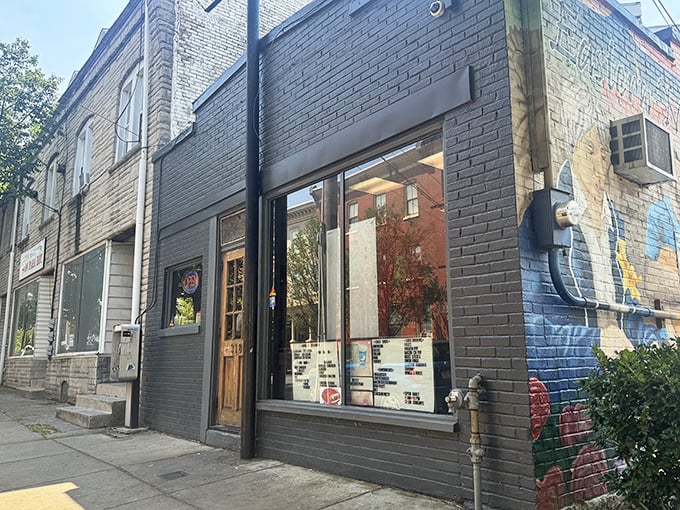 The unassuming gray brick exterior of Speed's with its wooden door marked "313" proves that culinary treasures often hide in plain sight.