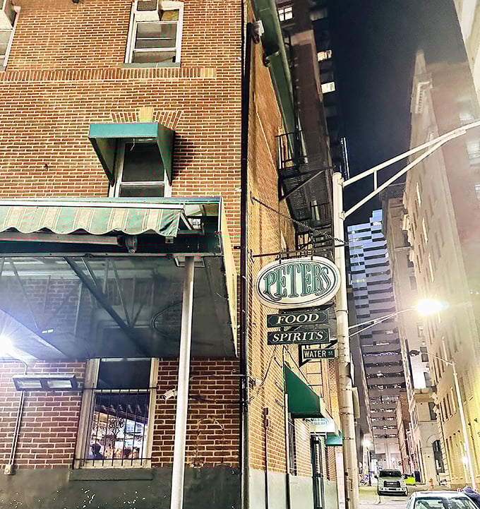 The unassuming brick exterior of Peter's Pour House stands like a culinary sentinel in downtown Baltimore, its vintage sign promising simple pleasures within.