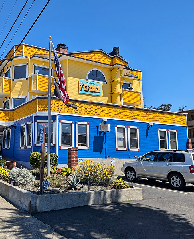 The bright blue and yellow exterior of Breakwater Barbecue stands out like a beacon of hope for hungry travelers along Highway 1.