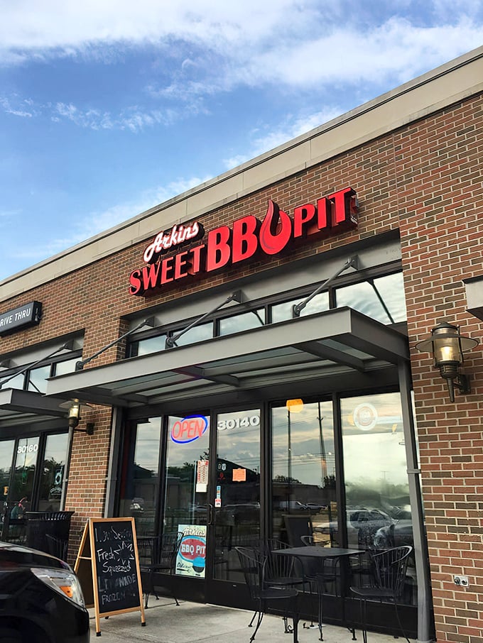 The red signage against brick isn't just decoration—it's a beacon calling to barbecue pilgrims seeking smoky salvation in Southfield.