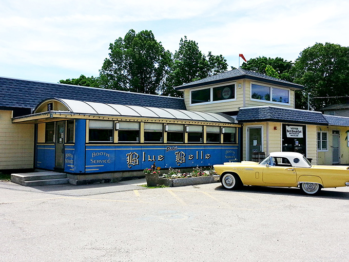 The classic blue exterior of Dinky's Blue Belle Diner stands proudly in Shrewsbury, complete with vintage car—a time capsule of Americana waiting to serve you breakfast.