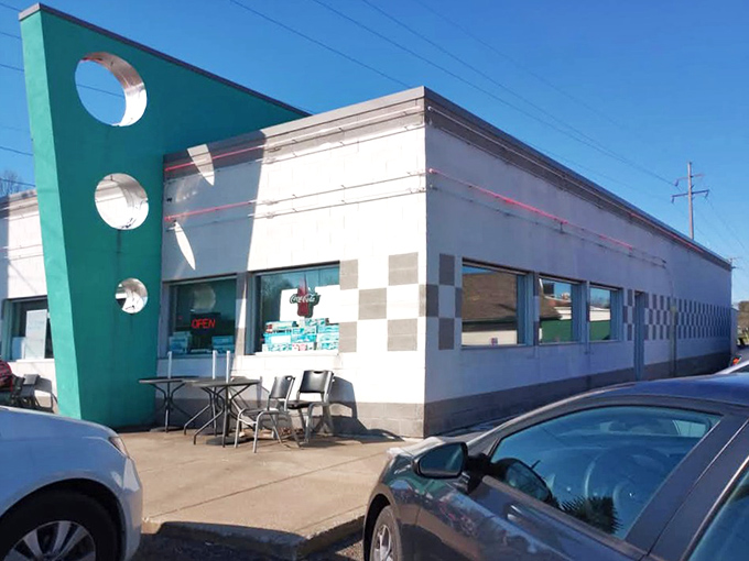 The turquoise fin-like accent wall isn't just architectural flair—it's a time machine disguised as a diner. Welcome to retro paradise.