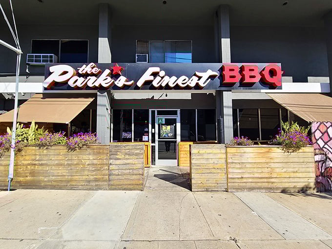The unassuming storefront of The Park's Finest beckons with its simple wooden patio barriers and bold signage—proof that culinary treasures often hide in plain sight.