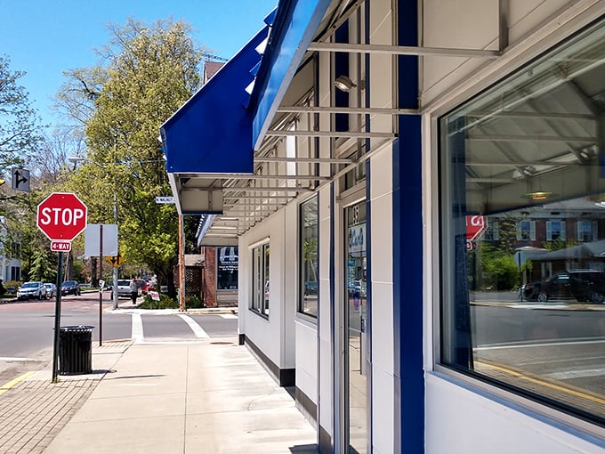 That iconic blue and white striped awning isn't just eye-catching—it's a time portal to when diners were the heart of American towns.