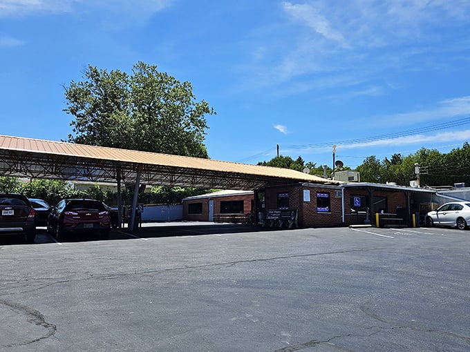 The parking lot view reveals the restaurant's practical charm - no valet parking here, just honest food waiting under that utilitarian overhang.