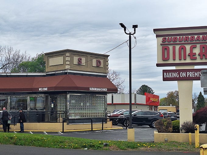 The classic diner silhouette that promises comfort before you even walk through the door. That "Baking On Premises" sign is the food equivalent of "In God We Trust."