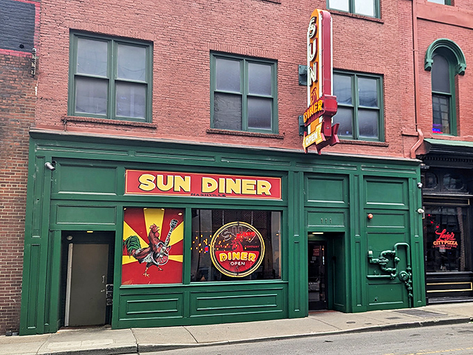 The emerald-green storefront of Sun Diner pops against Nashville's brick backdrop, its rooster logo promising both musical nostalgia and breakfast bliss on 3rd Avenue.