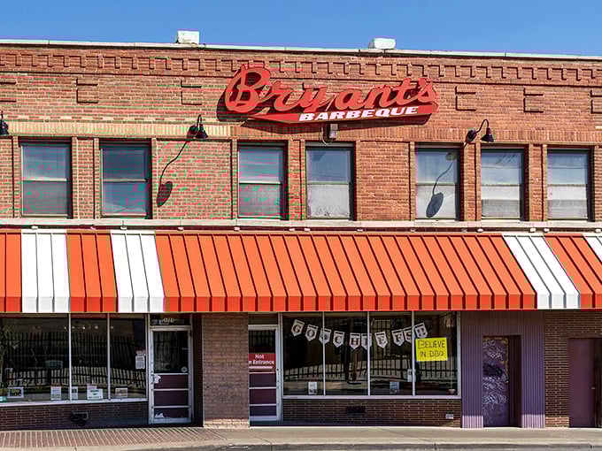 The brick fortress of flavor stands proudly with its iconic red and white awning—a Kansas City landmark that's been drawing barbecue pilgrims for generations.