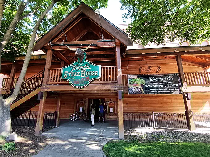 The rustic wooden facade of Hamley Steakhouse beckons like a time portal to the Wild West, complete with that iconic green sign promising carnivorous delights.