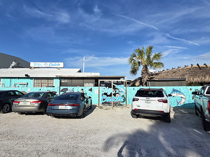 The turquoise facade of The Big Catch isn't trying to hide – it's proudly announcing that Florida seafood magic happens here, no reservations about reservations.