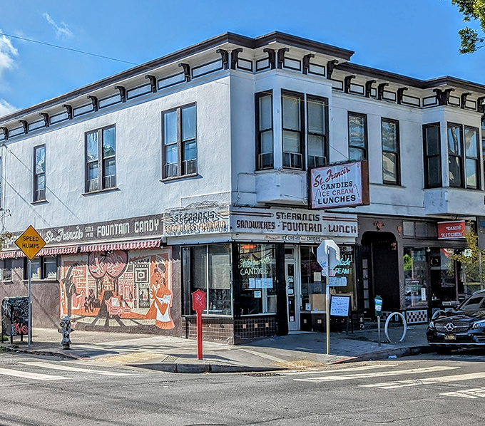 The iconic St. Francis Fountain storefront stands as a time capsule on the corner of 24th Street, its vintage signage promising simple pleasures that never go out of style.