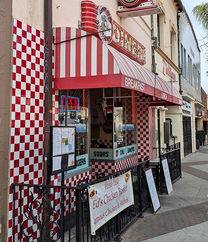 The red and white checkerboard facade isn't just eye-catching—it's a time portal to when Elvis topped the charts and milkshakes came with two straws.