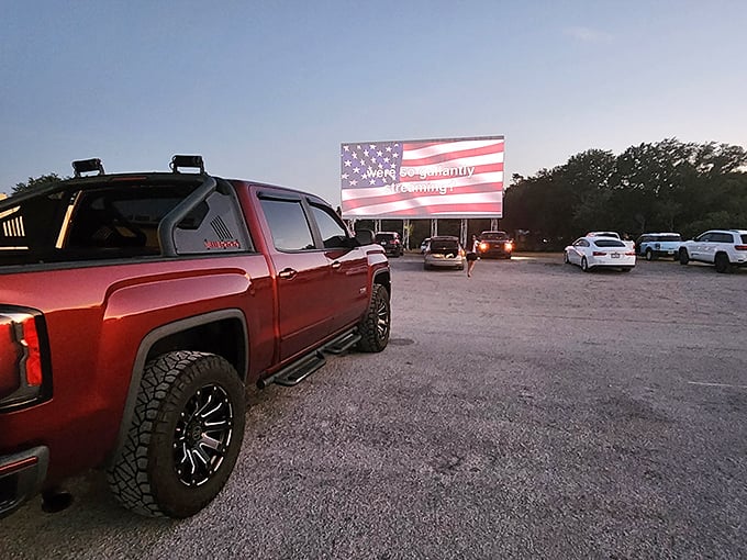 American nostalgia at its finest—where pickup trucks and patriotism meet under the glow of a massive outdoor screen.