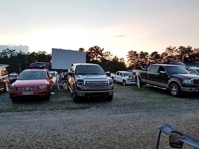 Twilight settles over the Swan Drive-In as trucks and cars claim their spots, the blank screen promising cinematic magic under Georgia stars.
