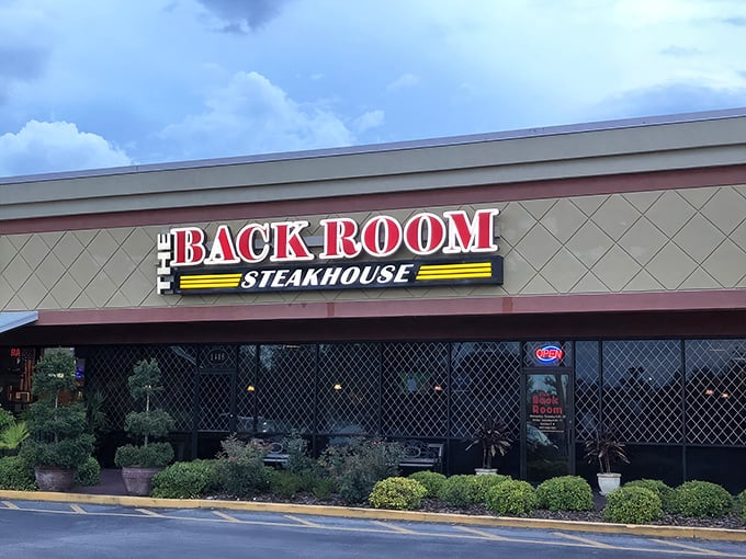 The bold red signage of The Back Room Steakhouse beckons from its Apopka strip mall home like a beacon for beef lovers seeking salvation from chain restaurant mediocrity.