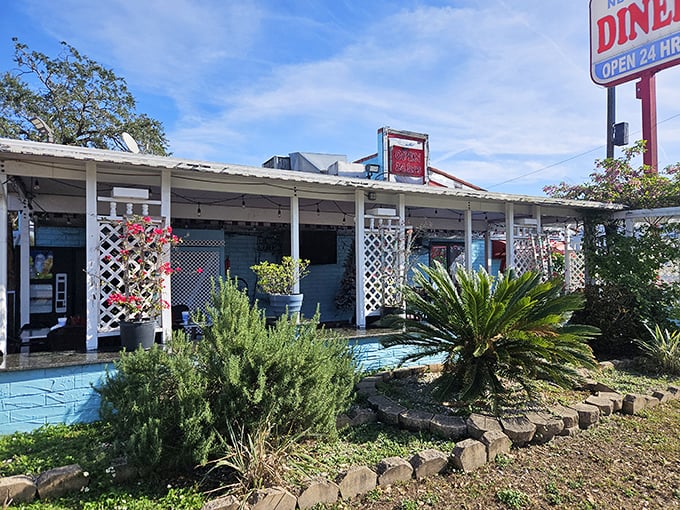 The light blue exterior with white lattice feels like Florida's answer to a New York diner – tropical plants included, no winter coat required.