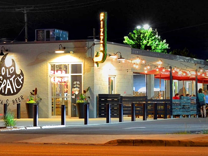 The unassuming exterior of Old Scratch Pizza belies the culinary magic happening inside. That flame logo isn't just for show—it's a promise of fire-kissed perfection.