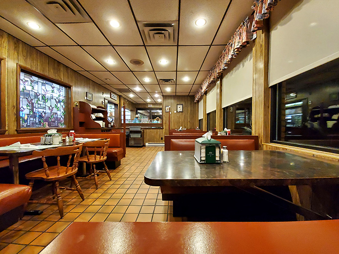 Classic diner charm at its finest—wood paneling, tile floors, and red vinyl booths that have witnessed countless coffee refills and life-changing pie decisions.