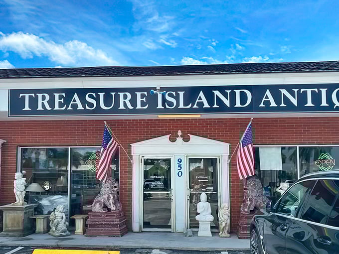 The sun-drenched façade of Treasure Island Antiques beckons with patriotic flair, promising air-conditioned adventures through decades of American nostalgia.