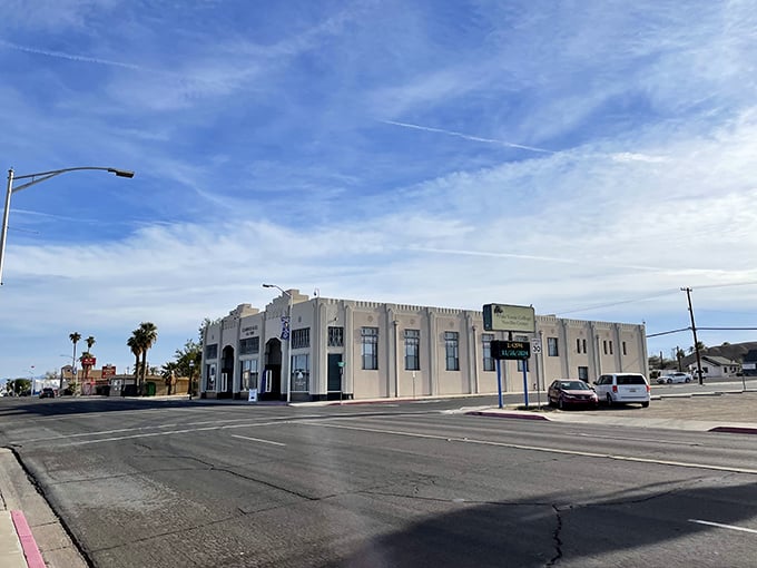 The El Garces Hotel stands like a white desert mirage, its historic architecture a testament to Needles' railroad glory days. Blue skies promise endless possibilities.