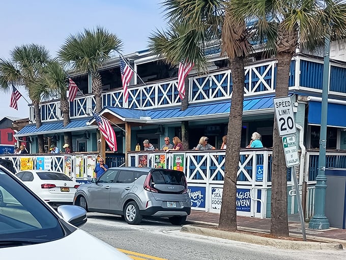 Flagler Tavern's iconic blue and white facade welcomes seafood lovers with swaying palms and a breezy wraparound porch perfect for people-watching.