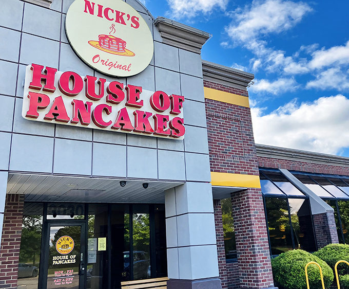 The iconic red signage of Nick's Original House of Pancakes stands out against Michigan's blue sky – a beacon for breakfast enthusiasts seeking morning salvation.