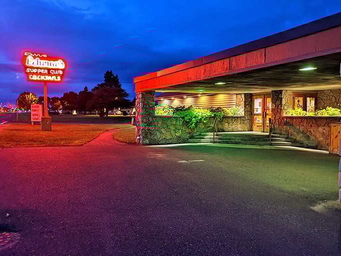 The neon glow of Lehman's sign against the twilight sky – a beacon calling hungry travelers to Wisconsin's temple of prime rib.