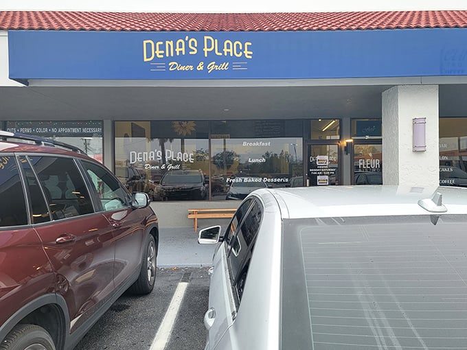 The bright blue exterior of Dena's Place stands like a beacon of breakfast hope in Lakeland. No fancy frills, just the promise of honest-to-goodness comfort food waiting inside.