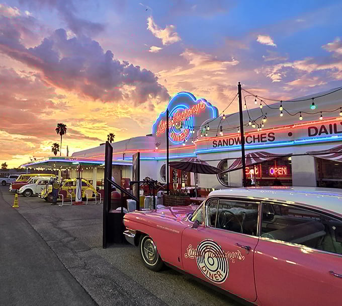 Sunset magic at Little Anthony's Diner, where that pink Cadillac isn't just decoration—it's a time machine with whitewalls and chrome.