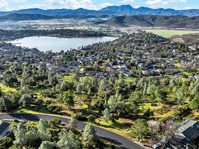 A bird's-eye view that makes you wonder if Bob Ross painted this landscape himself—nature's masterpiece of blue water embraced by California's rolling hills.