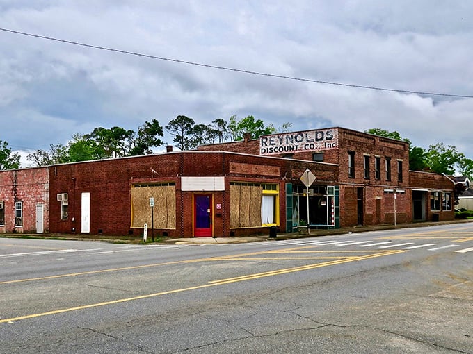 Reynolds Discount Co. stands as a brick sentinel of small-town commerce, its weathered façade telling stories of generations who've shopped its aisles.