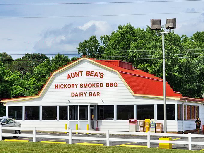 The iconic red-roofed building stands like a barbecue beacon, promising hickory-smoked delights that have made it a North Carolina pilgrimage site.