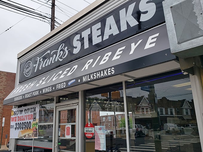 The iconic Frank's Steaks storefront beckons like a beacon of hope for the cheesesteak-deprived. That "FRESH SLICED RIBEYE" promise isn't just signage—it's a solemn vow.
