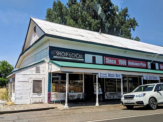 The white clapboard facade of Adin Supply Co stands like a time capsule against the California sky, beckoning hungry travelers with promises of "Delicious Pizza" since 1906.