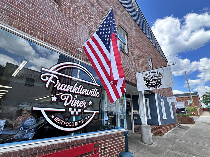 The American flag stands proud outside this brick-faced treasure – Franklinville Diner promises "Best Food in Town" and delivers on that patriotic pledge.