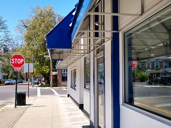 That iconic blue and white striped awning isn't just eye-catching—it's a time portal to when diners were the heart of American towns.