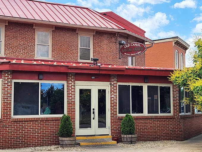 The classic brick exterior with its distinctive red metal roof beckons like an old friend promising comfort and satisfaction ahead.