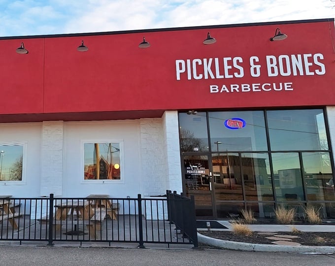 The bold red exterior of Pickles & Bones Barbecue isn't just a color choice—it's a warning sign that something seriously delicious is happening inside.