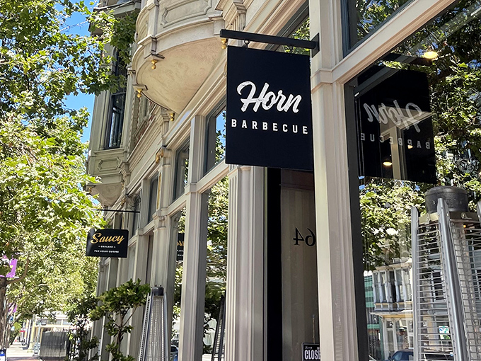 The striking longhorn mural on Horn Barbecue's exterior isn't just decoration—it's a promise of the primal, smoky delights waiting inside this Oakland treasure.