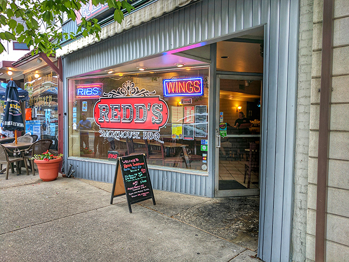 The unassuming blue storefront with its neon "RIBS" and "WINGS" signs promises what every BBQ pilgrim seeks: authentic flavor without pretense.