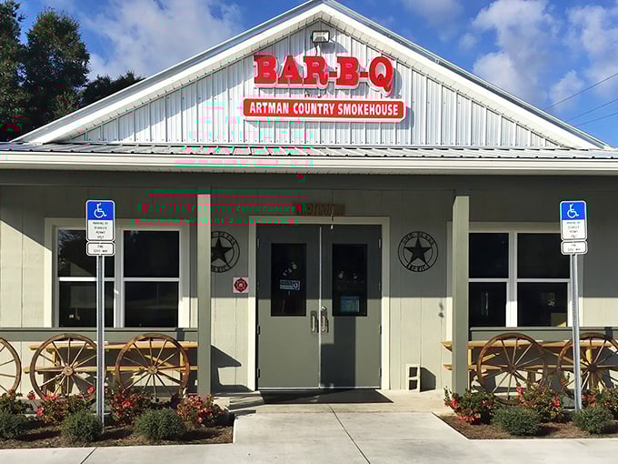 The unassuming exterior of Artman Country Smokehouse beckons with rustic charm. Those wagon wheels aren't just decoration—they're a promise of old-fashioned barbecue goodness waiting inside.