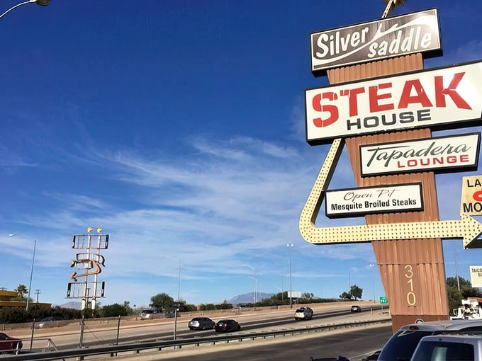 That vintage sign isn't just advertising – it's a beacon of hope for the hungry. Mesquite-broiled promises under the Arizona sky.