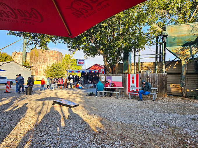 The pilgrimage begins here – a humble gravel lot under Texas skies where barbecue dreams come true and morning shadows stretch like hungry customers.