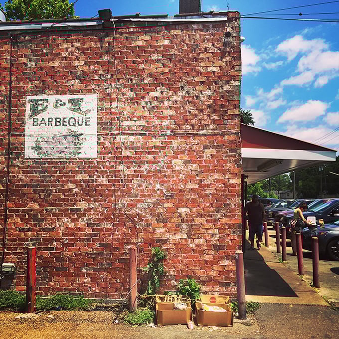 That weathered brick exterior isn't a marketing gimmick—it's a smoke-stained badge of honor earned through decades of barbecue excellence on Bailey Avenue.