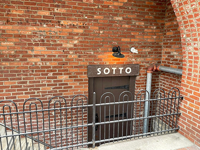 The unassuming entrance to Sotto feels like discovering a secret passageway to Italy. This brick-framed doorway marks the beginning of your underground culinary adventure.