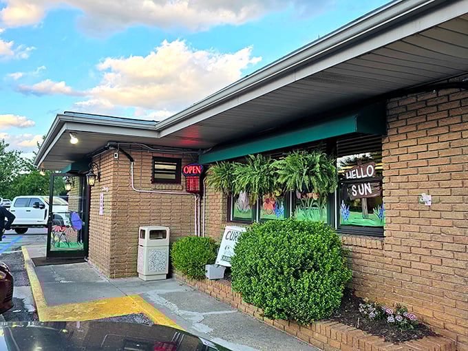 The distinctive green entrance panel flanked by lanterns gives Clyde's that perfect blend of mountain charm and no-nonsense diner appeal.