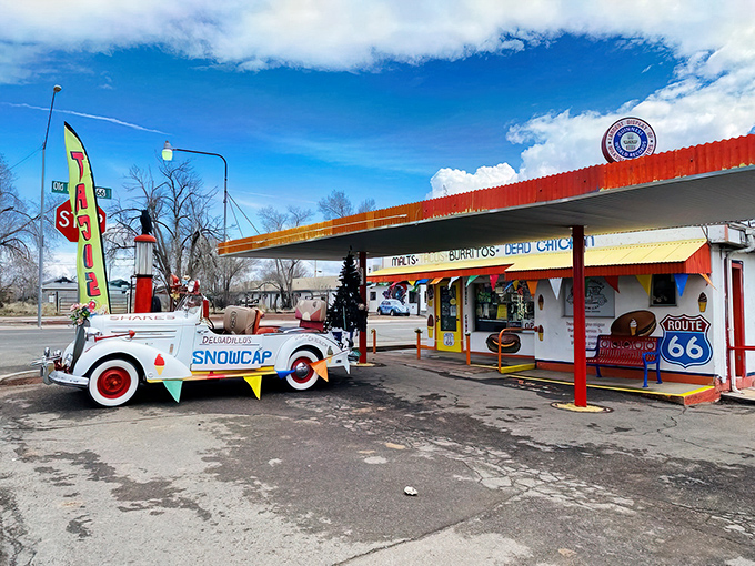 The technicolor dream coat of roadside diners! Delgadillo's Snow Cap stands proudly on Route 66, promising burgers, laughs, and a splash of Americana.
