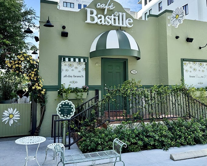 Café Bastille's charming exterior welcomes you with Parisian flair and fringe-adorned umbrellas—like a French postcard come to life in Fort Lauderdale.